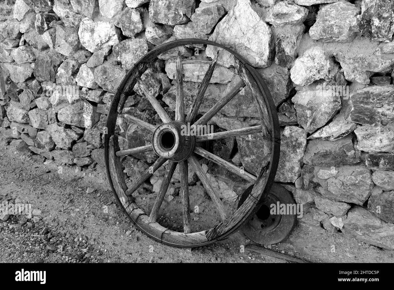 Old wooden wagon wheel and a stone wall Stock Photo - Alamy