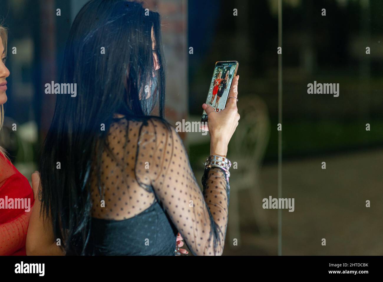 Selective focus of two beautiful caucasian and hispanic friends taking ...