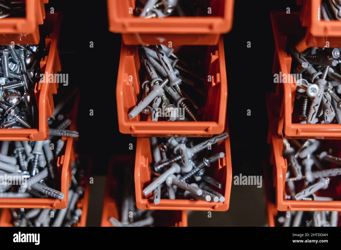 Small boxes with screws, wall plugs and nuts in a workshop Stock Photo ...