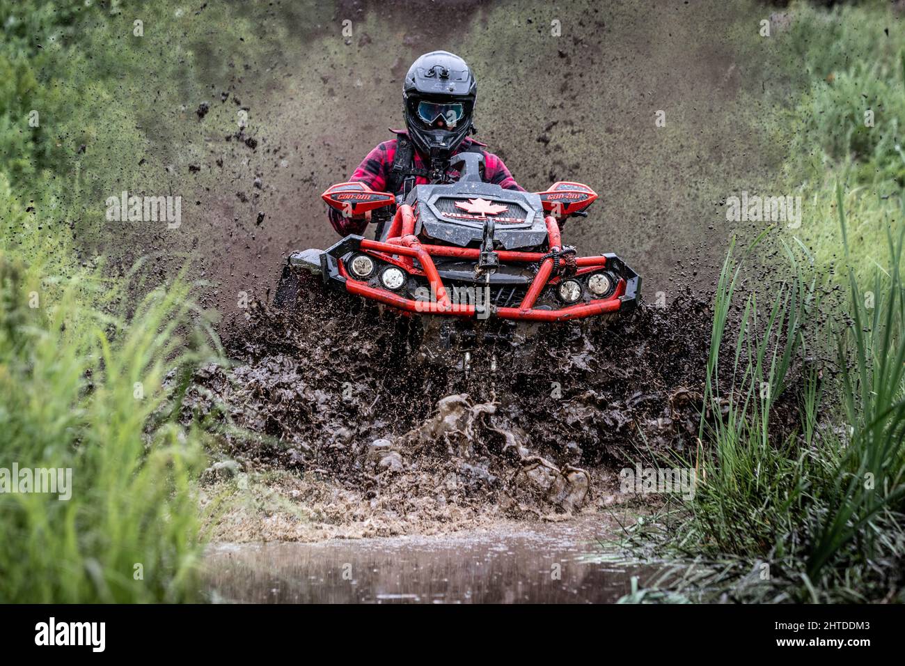 Man on Can-Am Outlander ATV Quad stuck in deep mud Stock Photo - Alamy