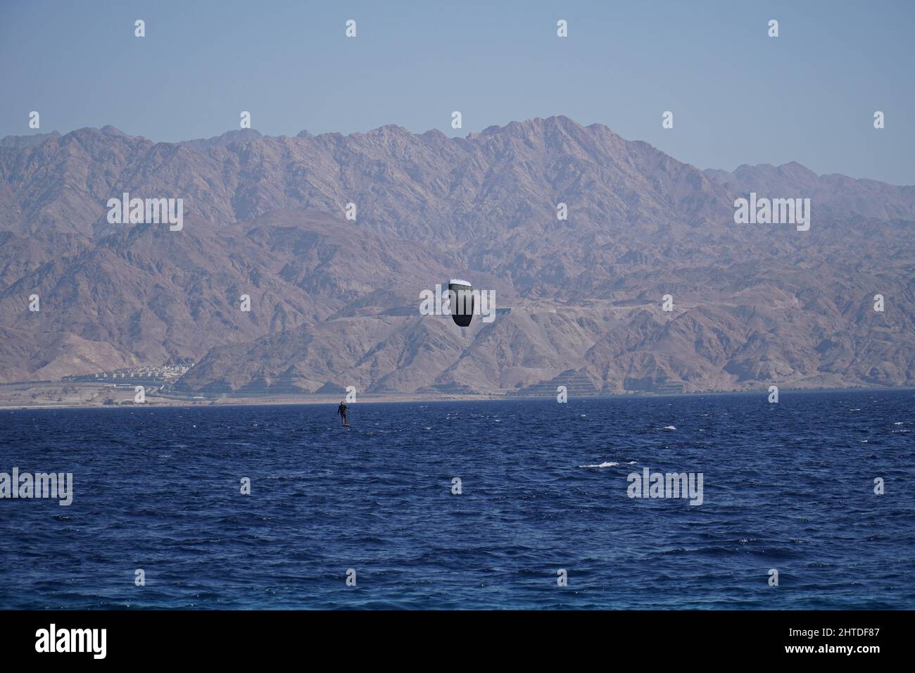 Wind surfing in the sea of Eilat, Israel with the city of Aqaba in ...