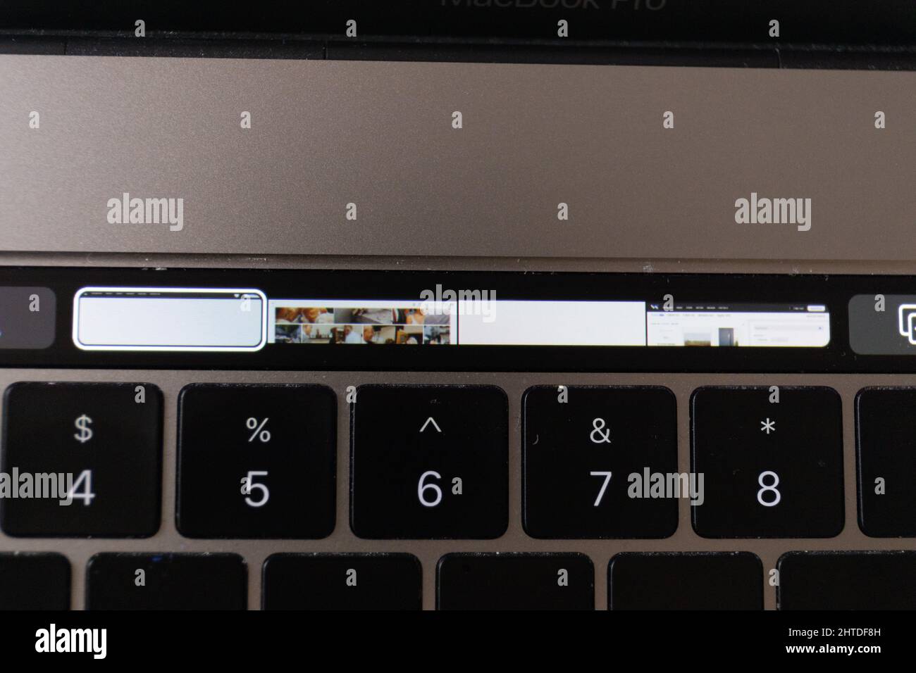 A top view of tabs open in Safari showing on touch bar of MacBook Pro ...