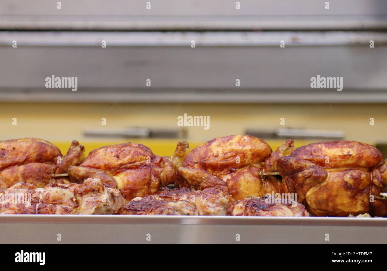 Selective focus of chicken rotisserie ready to grill at a restaurant ...