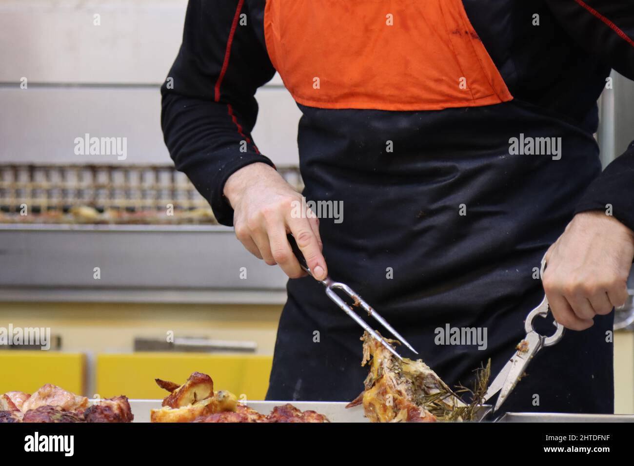 Selective focus of a chef preparing chicken with lots of ingredients ...