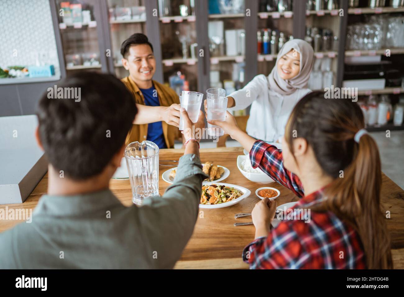 asian young people eating lunch together in the kitchen Stock Photo - Alamy