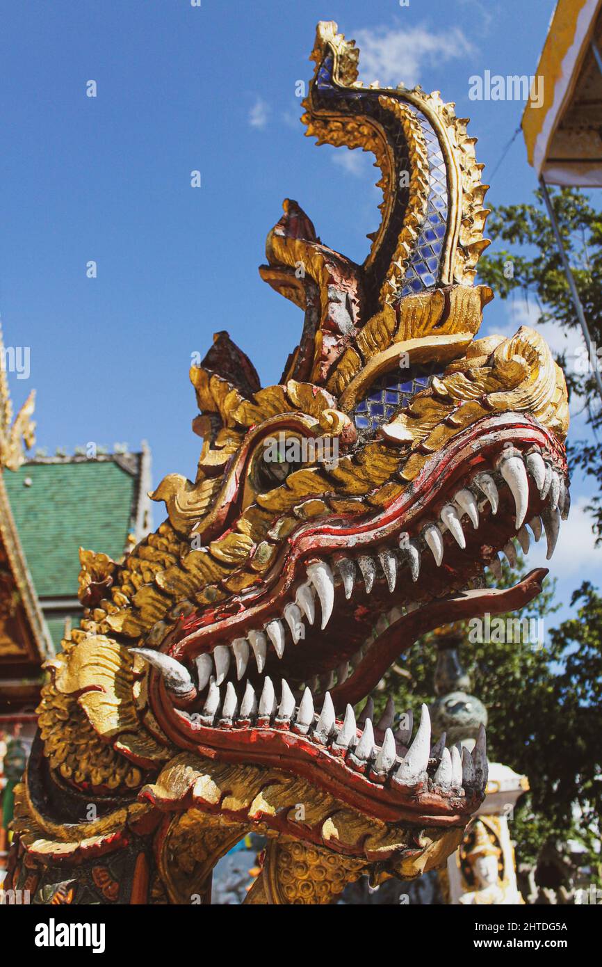 Low-angle shot of a Chinese dragon in the street against the blue sky ...