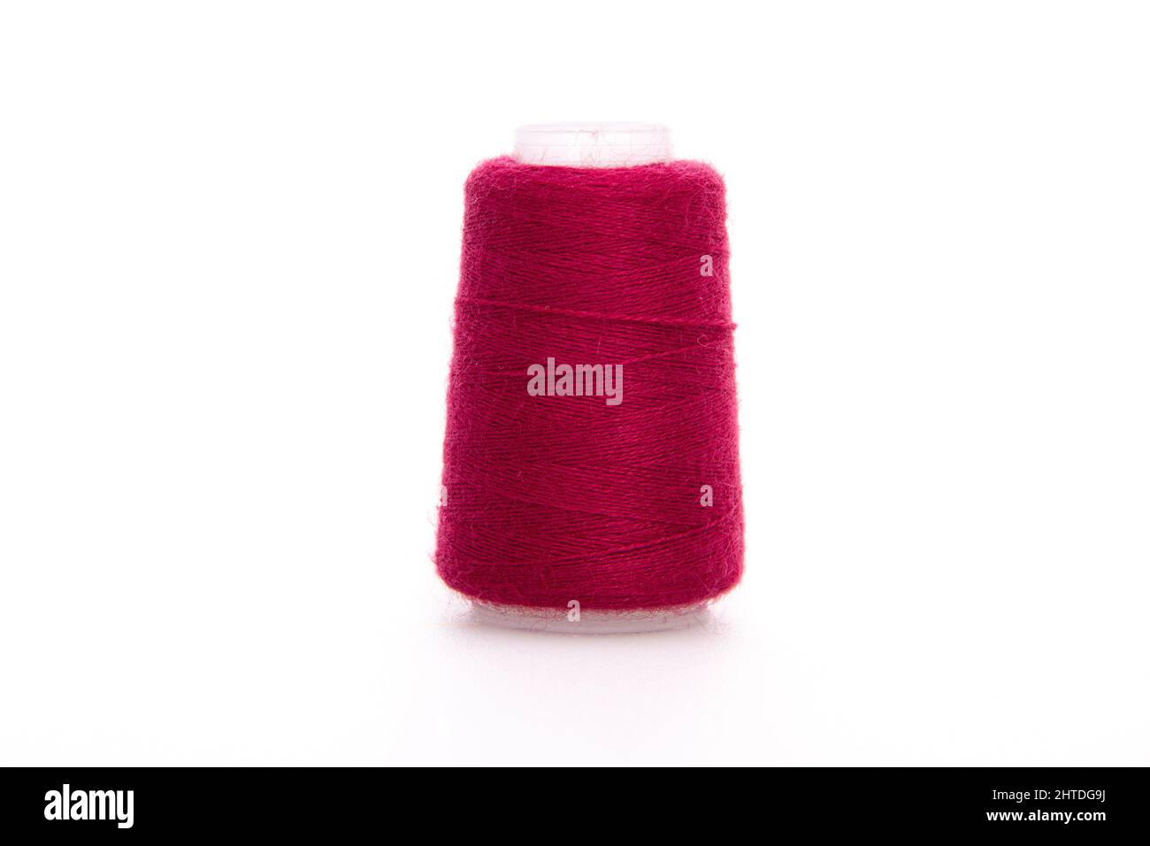 Red spool of thread isolated on white background. Skein of woolen ...