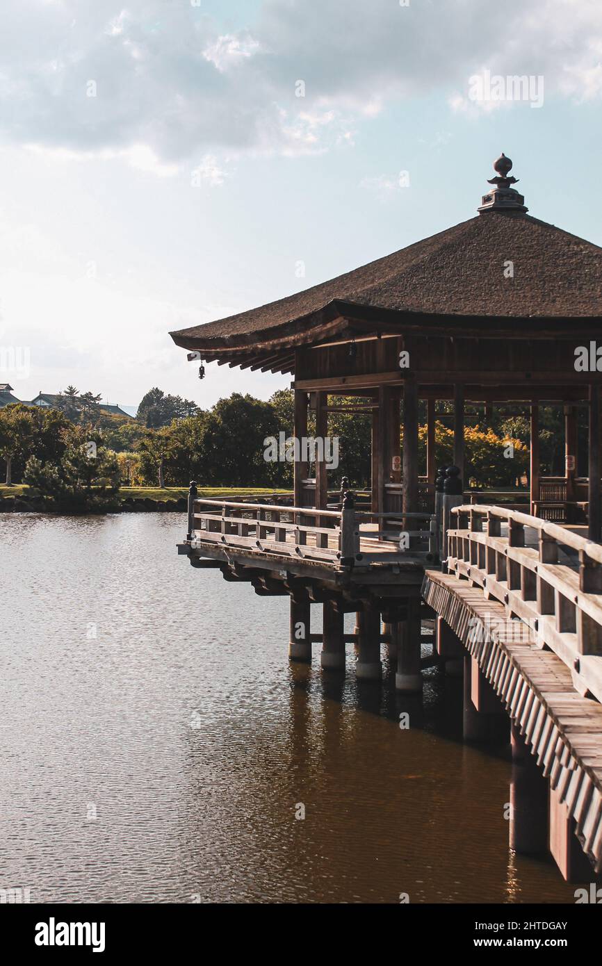 Old Japanese-style building against the cloudy sky over the lake Stock ...
