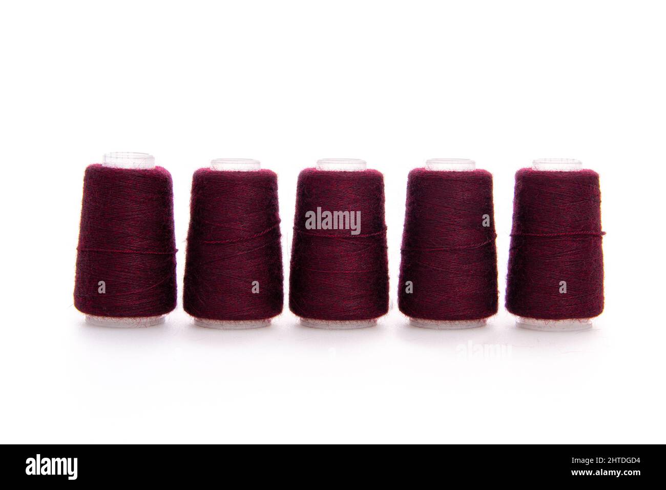 Red spool of thread isolated on white background. Skein of woolen ...