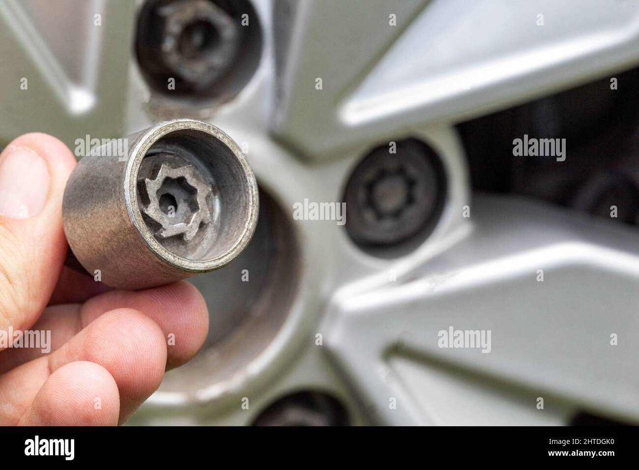 A secret bolt in a car wheel. Anti-theft protection, macro. Industry ...