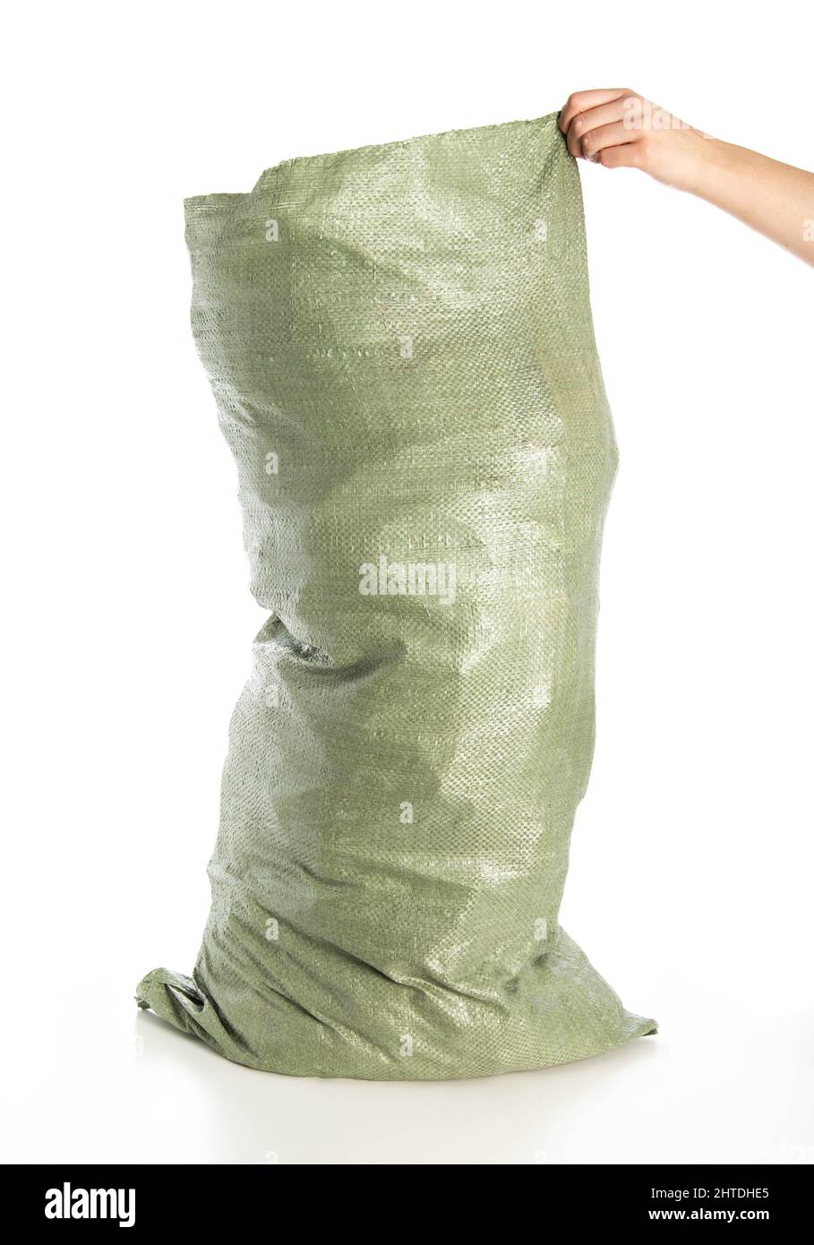 Full bag with construction debris in hand on a white background ...