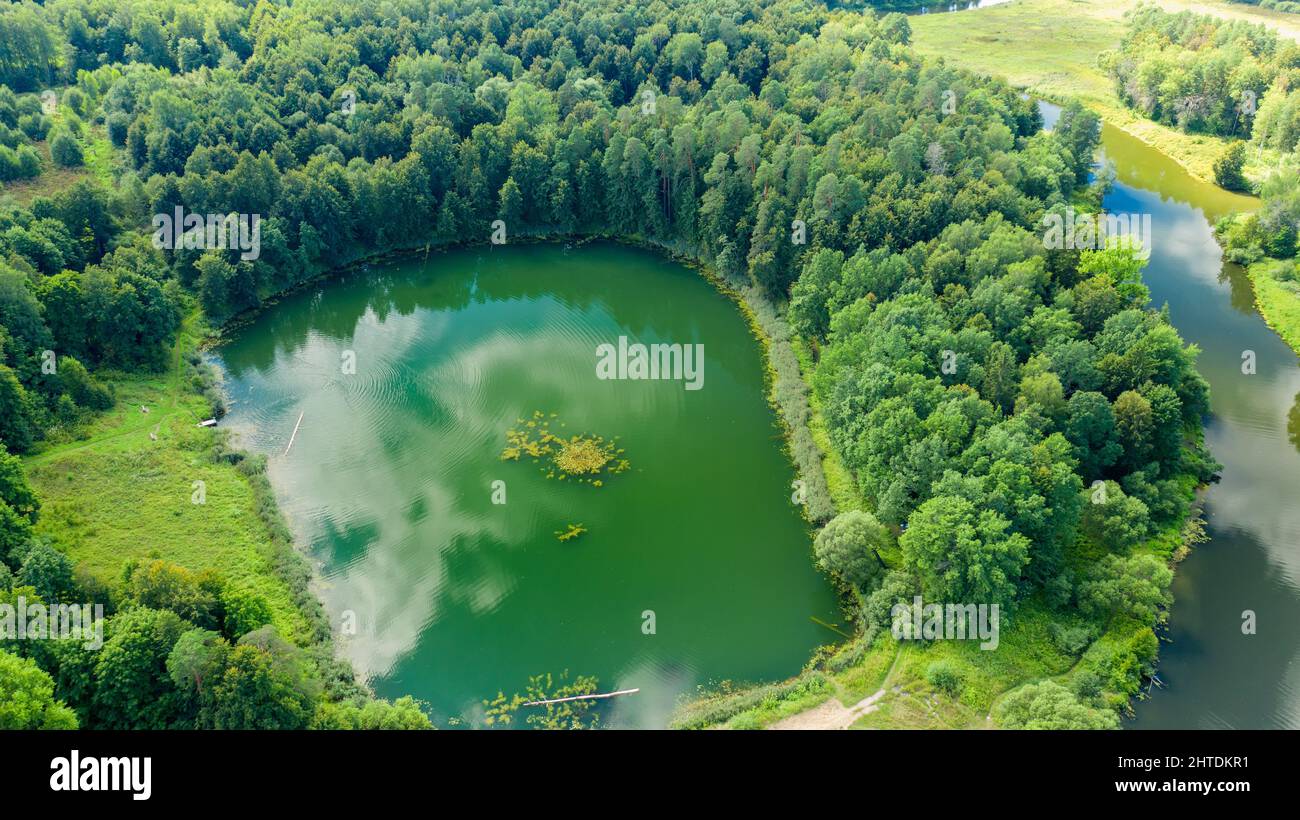 Aerial view of the countryside and a circular lake in the middle of the ...