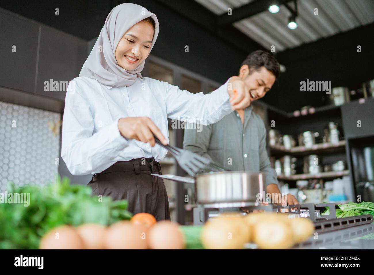 beautiful young muslim couple cooking together Stock Photo - Alamy