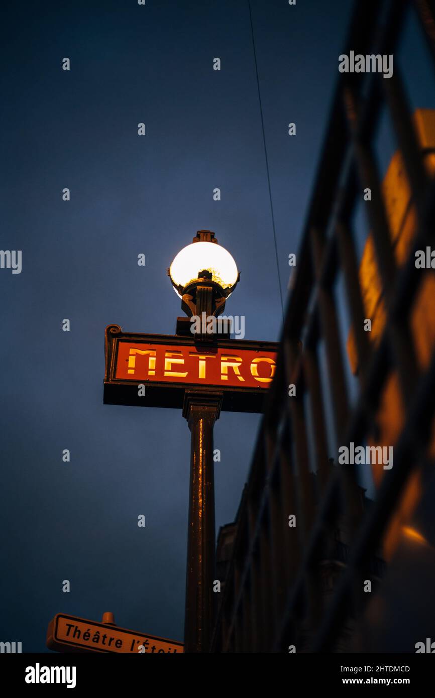 Metro sign under a street light in the evening Stock Photo - Alamy
