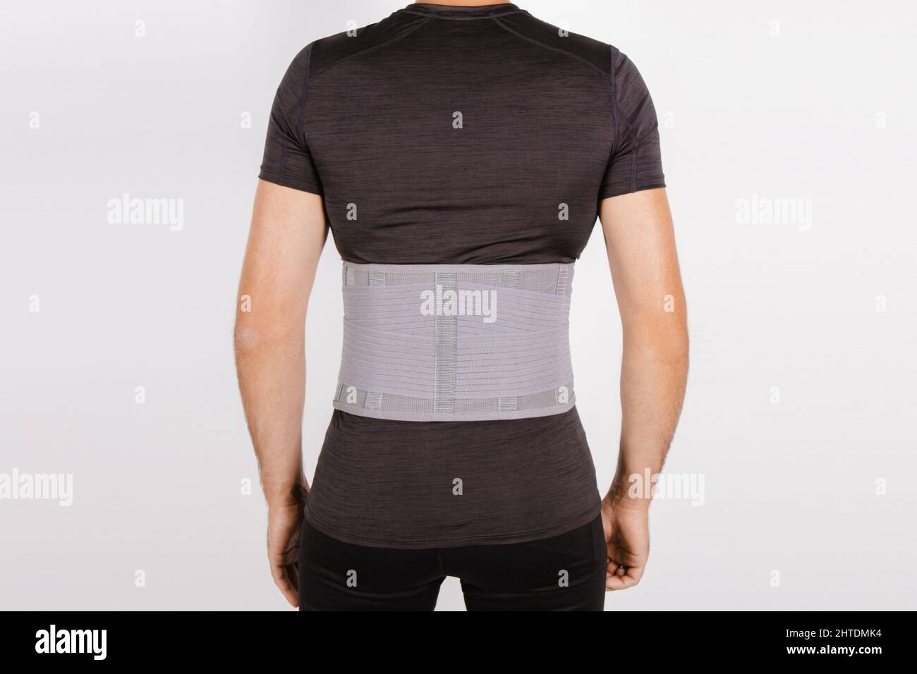 Lumbar brace on the human body isolated on a white background. Trauma ...