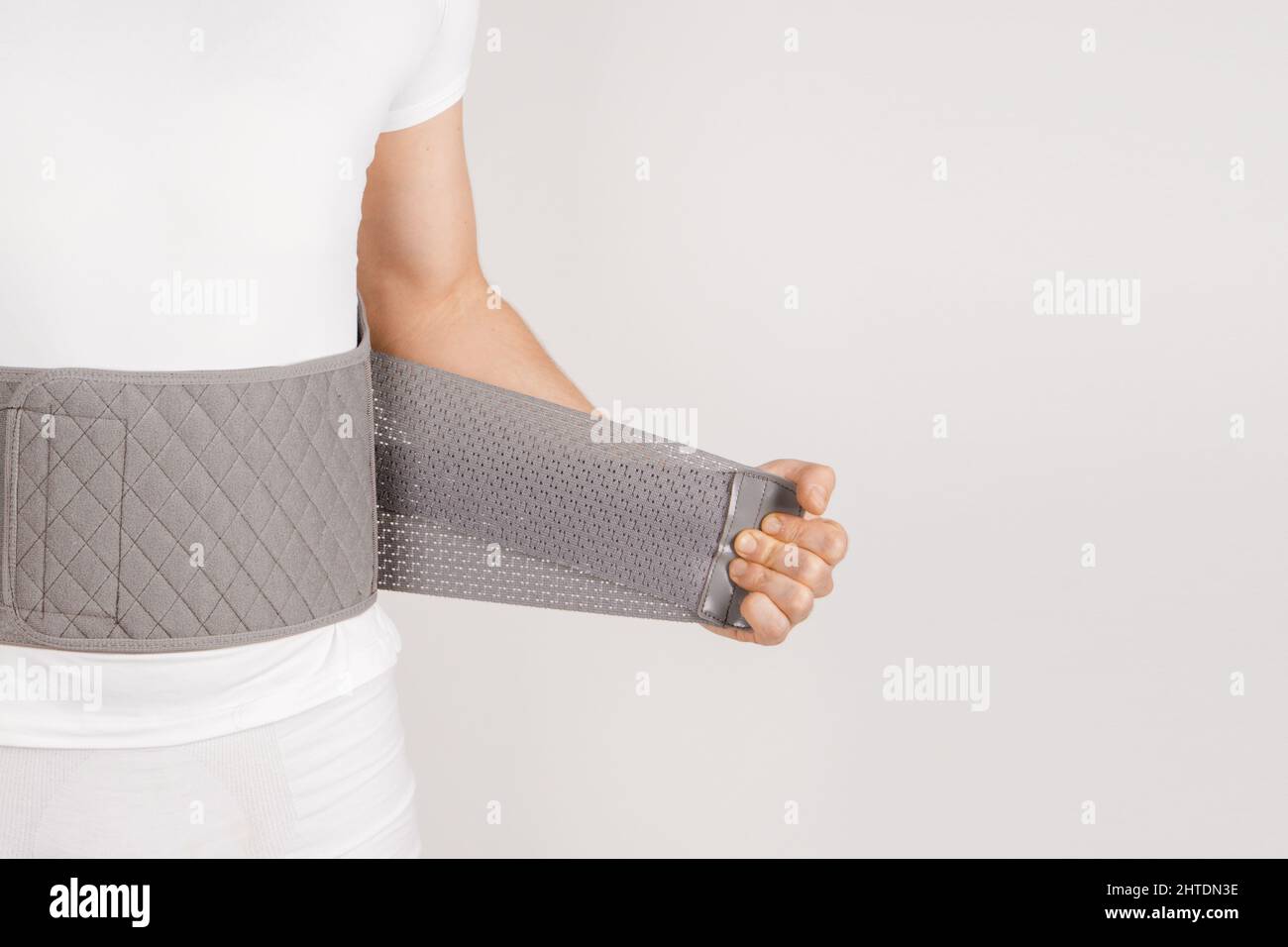 Lumbar brace on the human body isolated on a white background. Trauma ...