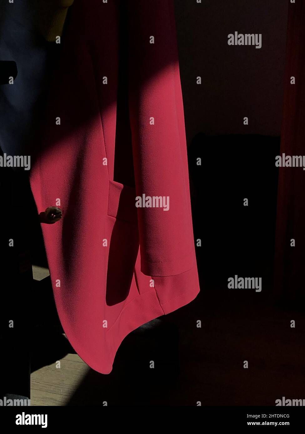Female jacket hanging in a dark room Stock Photo - Alamy