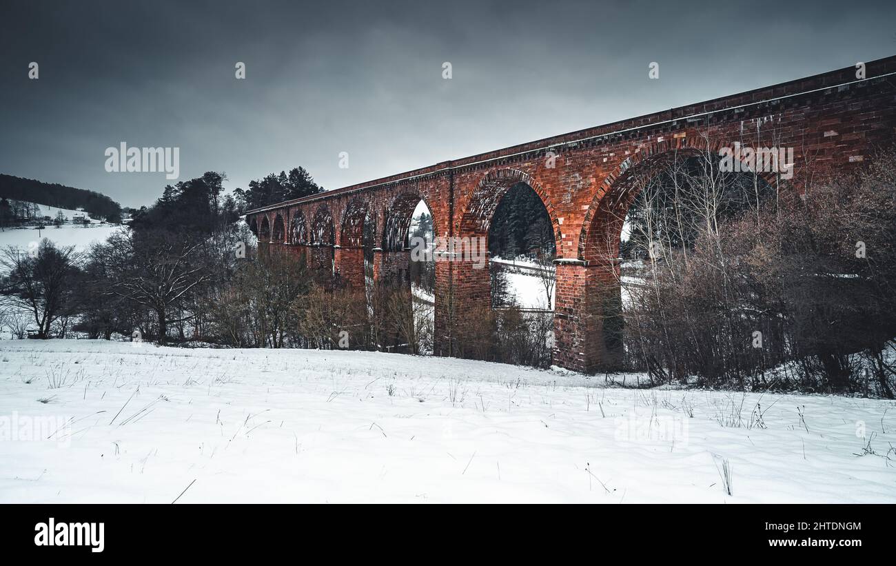 Scenic view of a brick bridge reflected in a lake on the background of ...