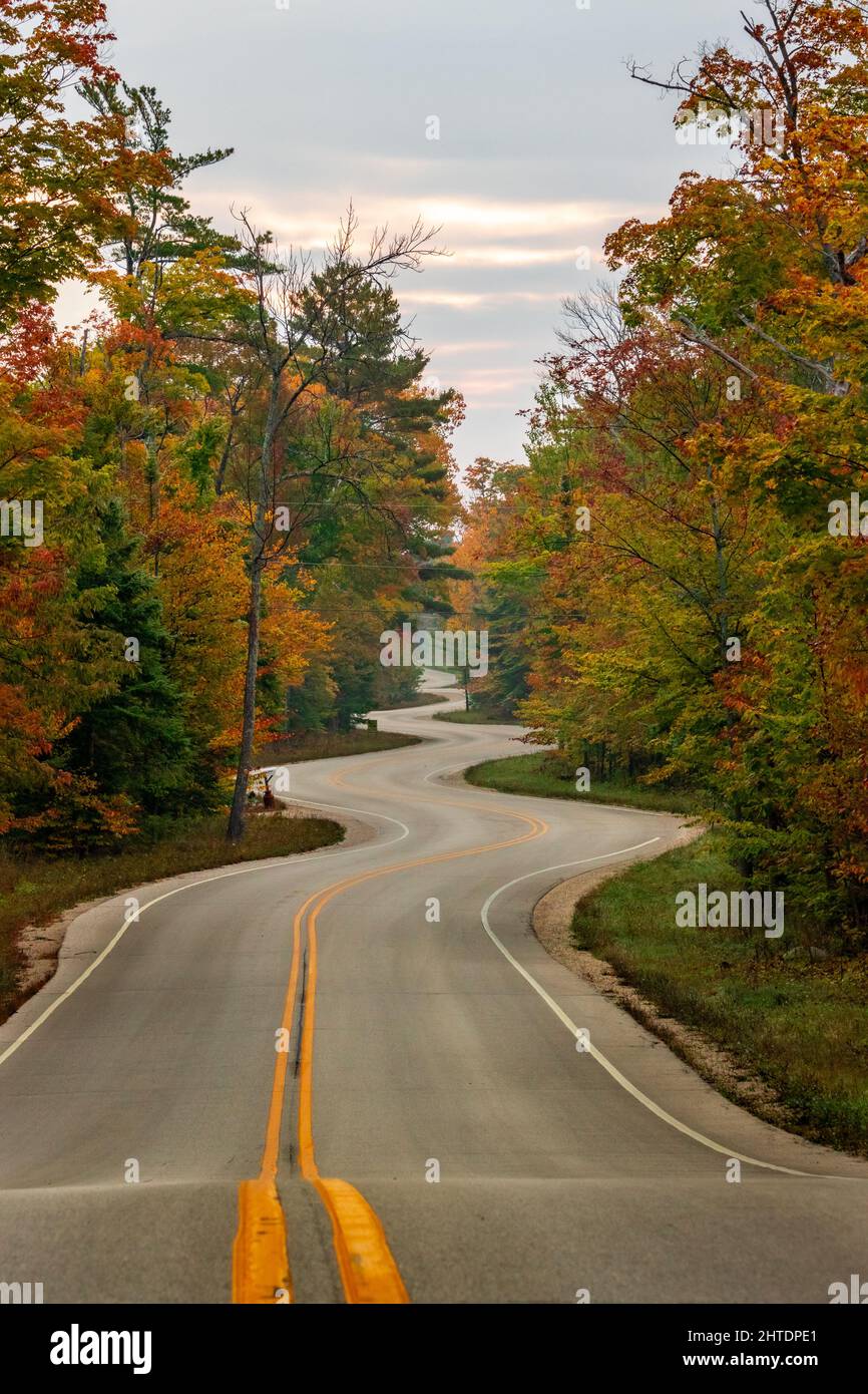 Bumpy curvy road through an autumn forest in Door County, Wisconsin ...