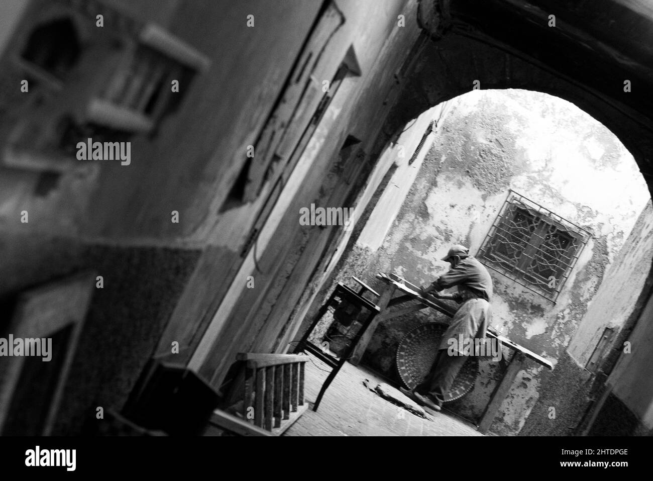 Grayscale of a man working Stock Photo - Alamy