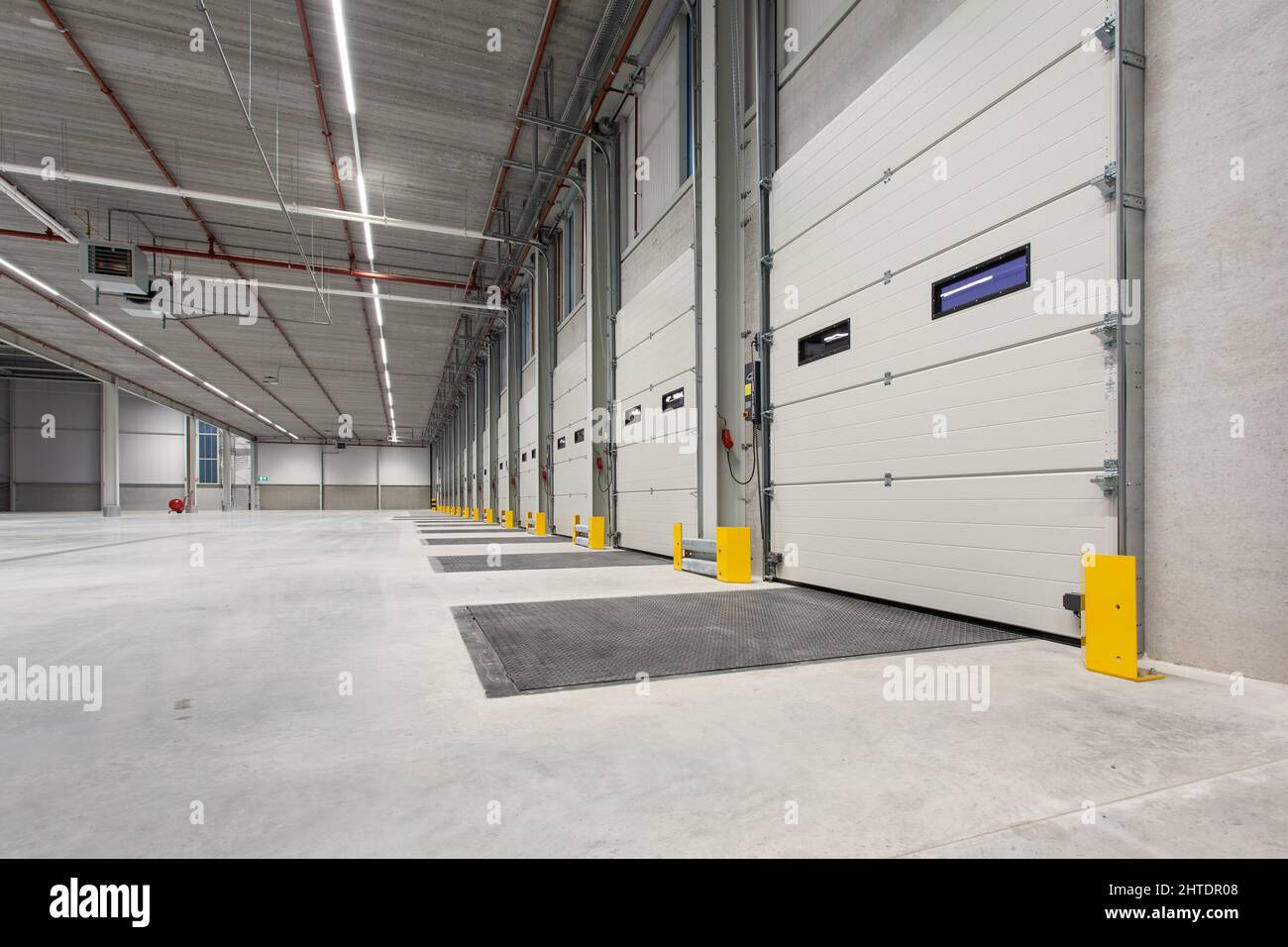 Interior of a new empty warehouse with loading docks ready to be used ...