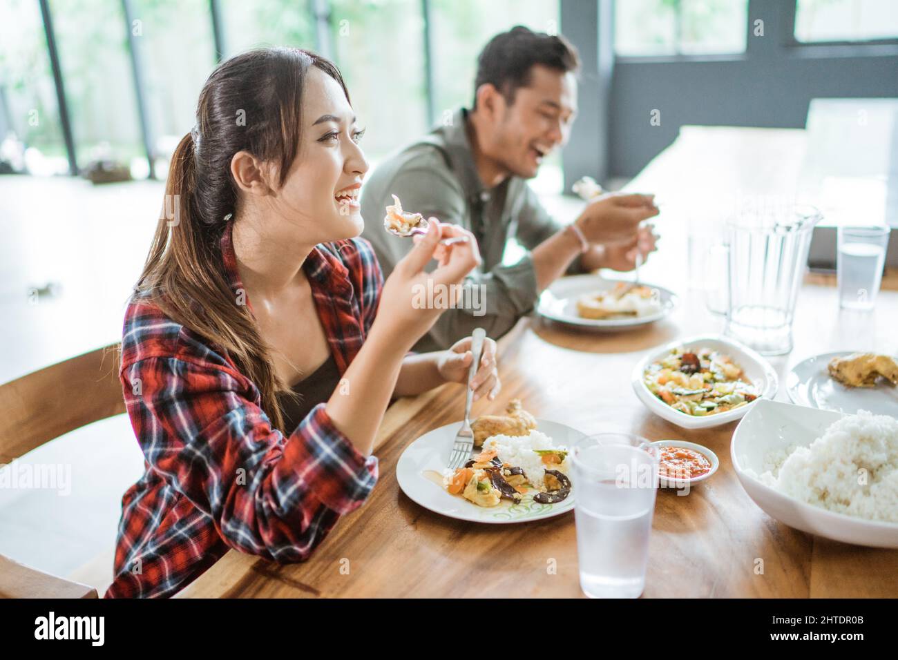 asian young people eating lunch together in the kitchen Stock Photo - Alamy