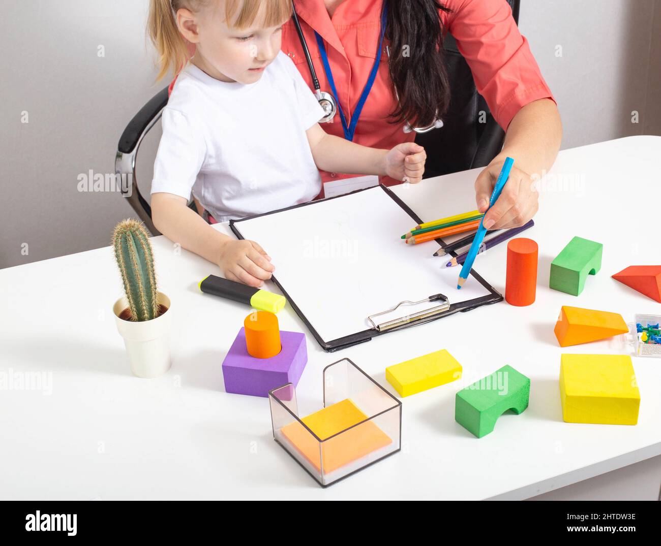 Doctor pediatrician draws with pencils with a little girl patient Stock ...