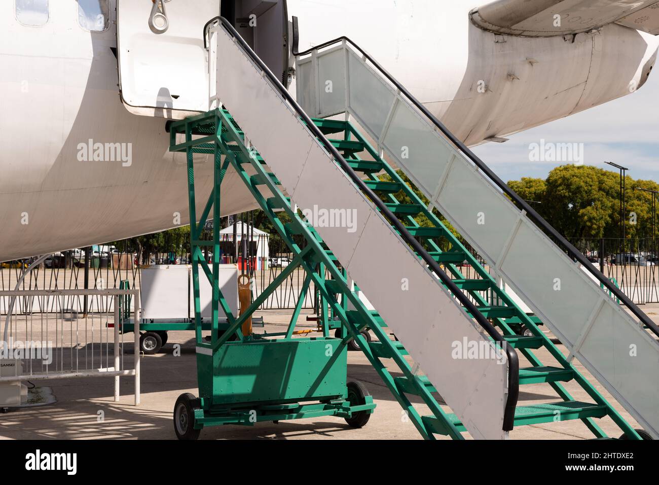 White and green boarding ladder at theentrance door of an airplane ...