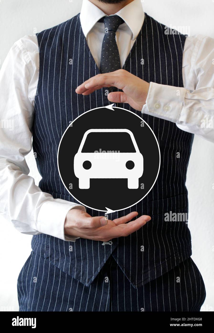 Businessman holding sign with a car symbol Stock Photo - Alamy