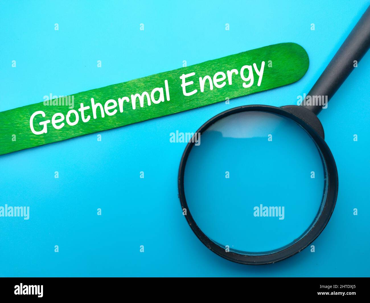 Magnifying glass and a green stick with the text "Geothermal Energy" on ...