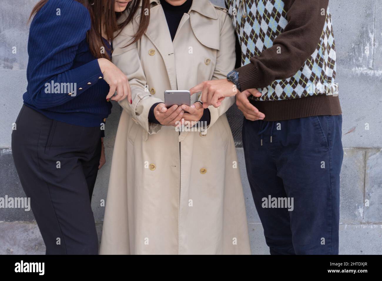 Office mates talking together while looking at the phone Stock Photo ...