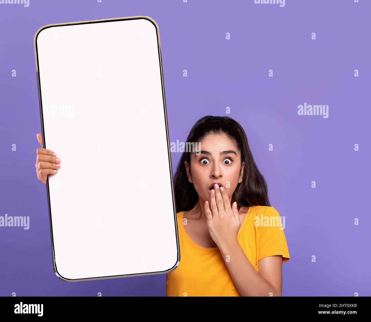 Surprised confused young arab lady covers her mouth with hand, shows ...