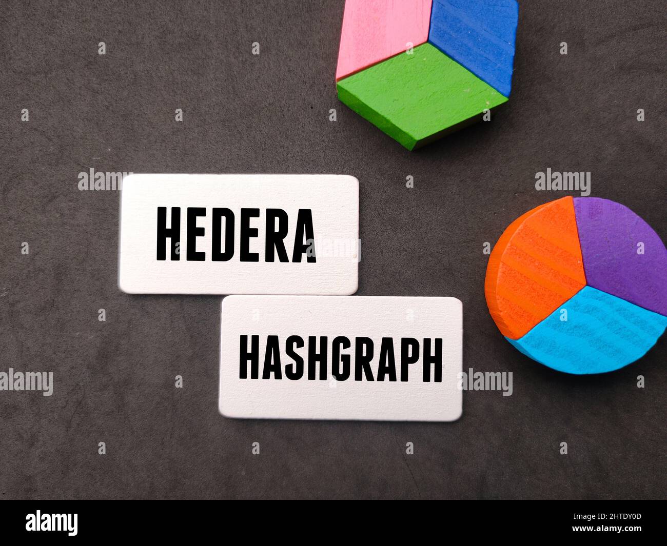 Boards with the text "Hedera hashgraph" with colorful cubes on black ...