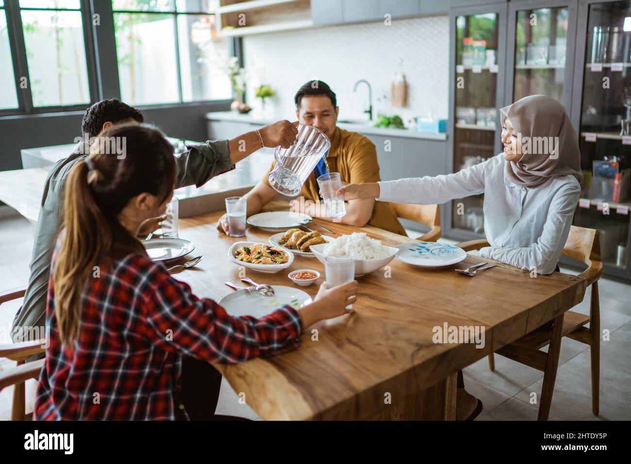 asian young people eating lunch together in the kitchen Stock Photo - Alamy