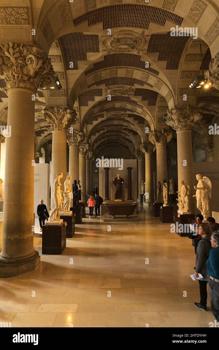 Display gallery with roman and greek statues in the Louvre museum in ...
