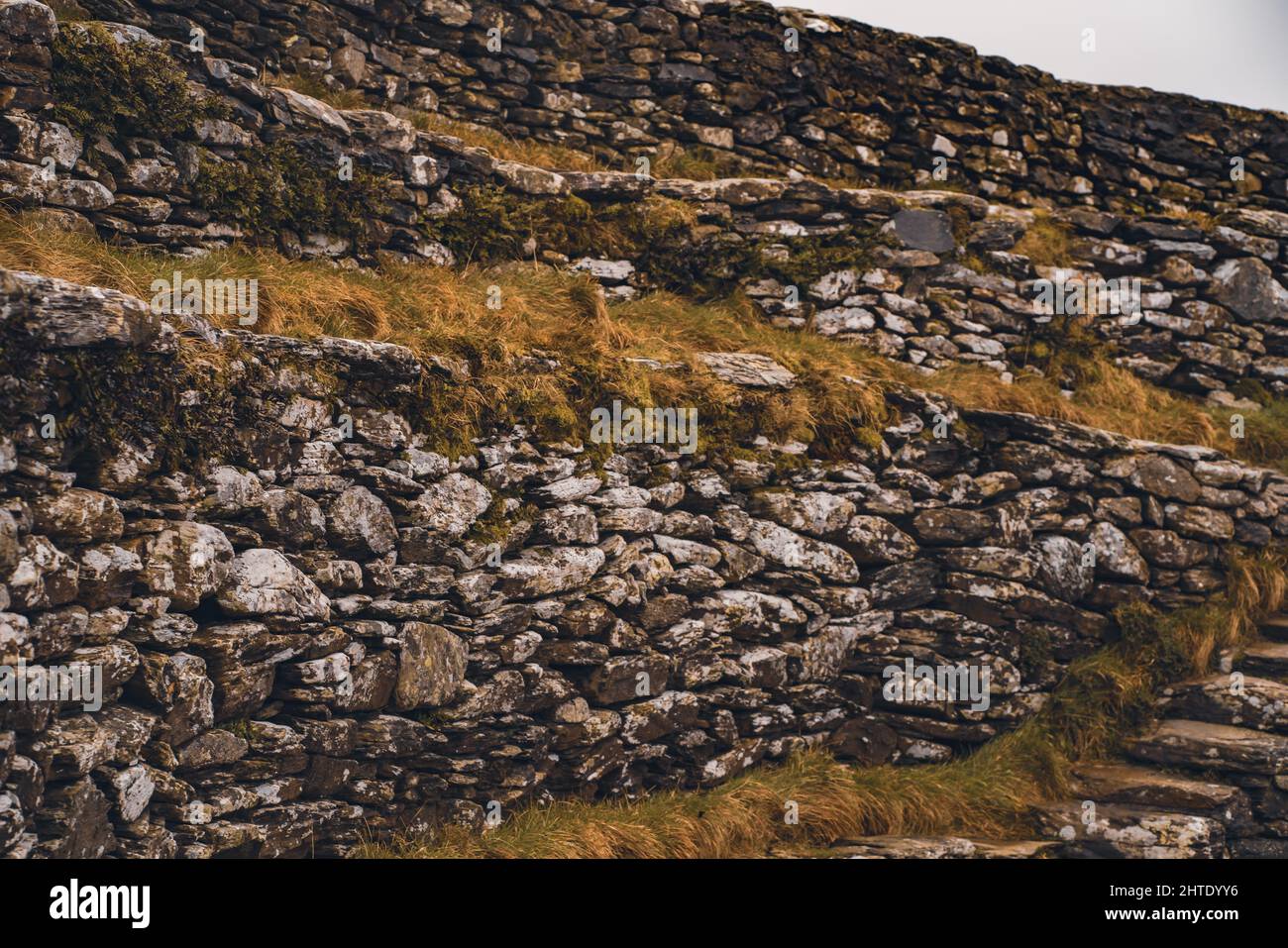 Natural view of piled rock walls with dried grasses in the countryside ...
