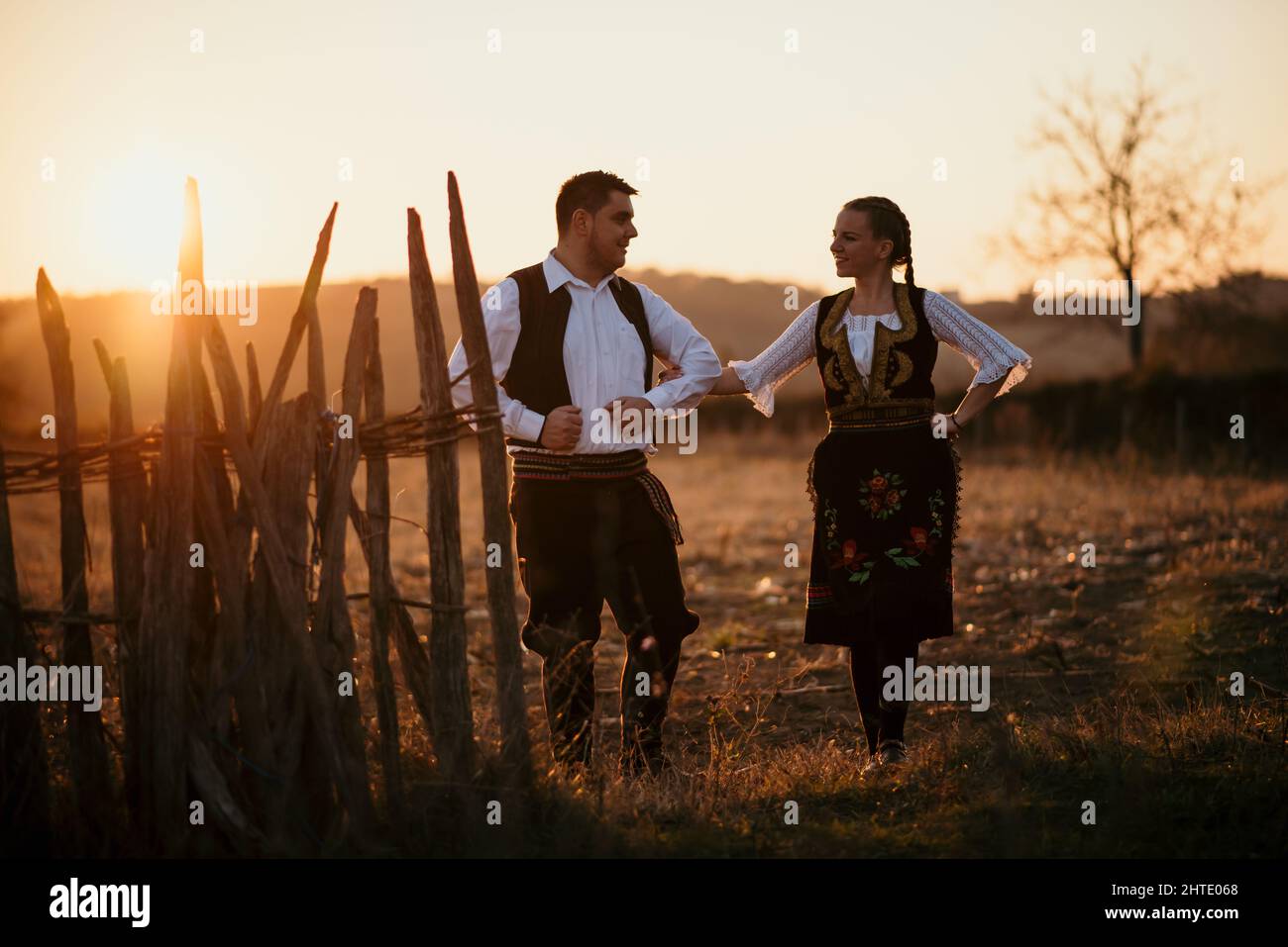 Beautiful shot of a Serbian couple in traditional costume having a good ...