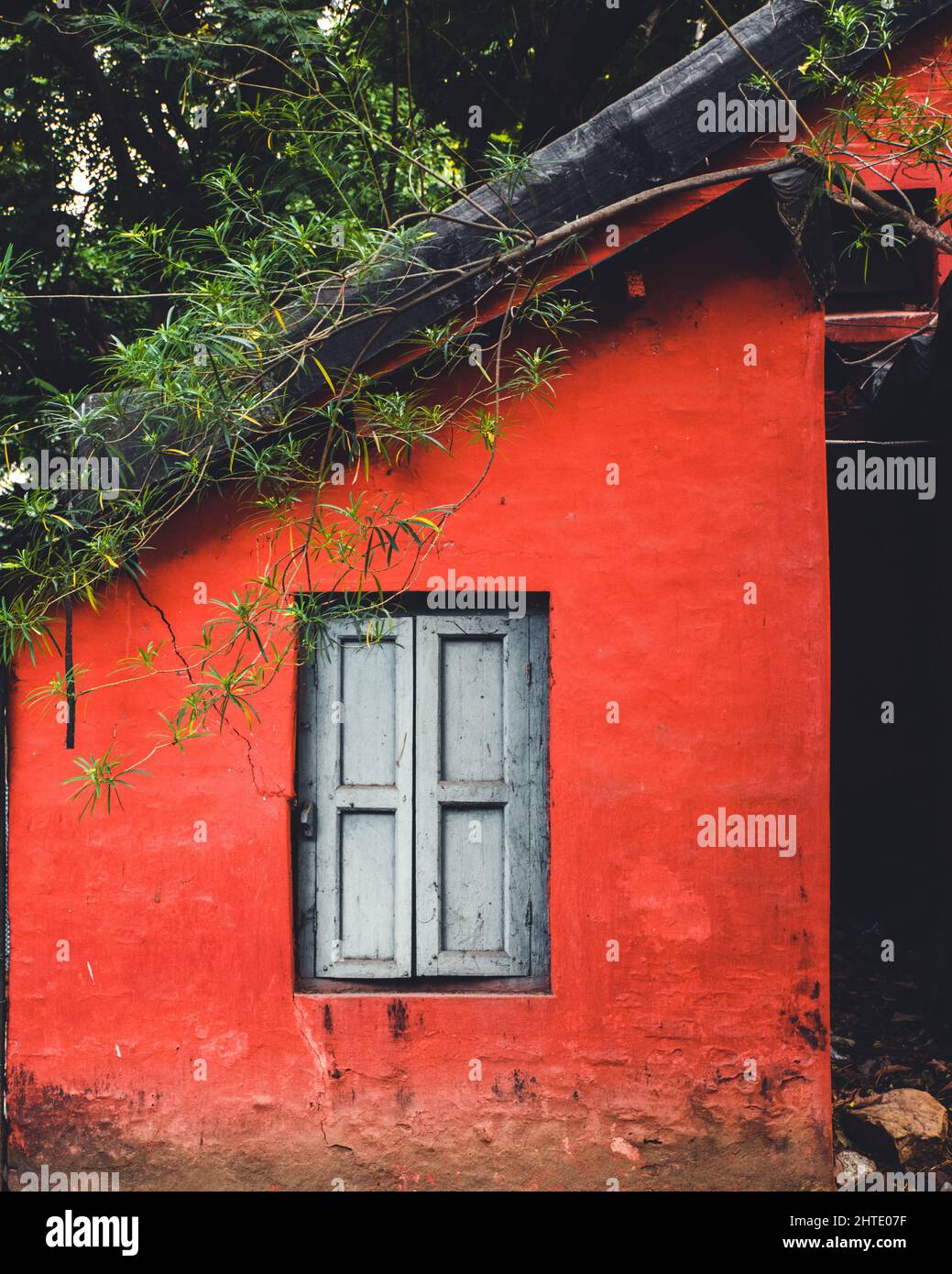 Closeup of a red old house with a white wooden window Stock Photo - Alamy