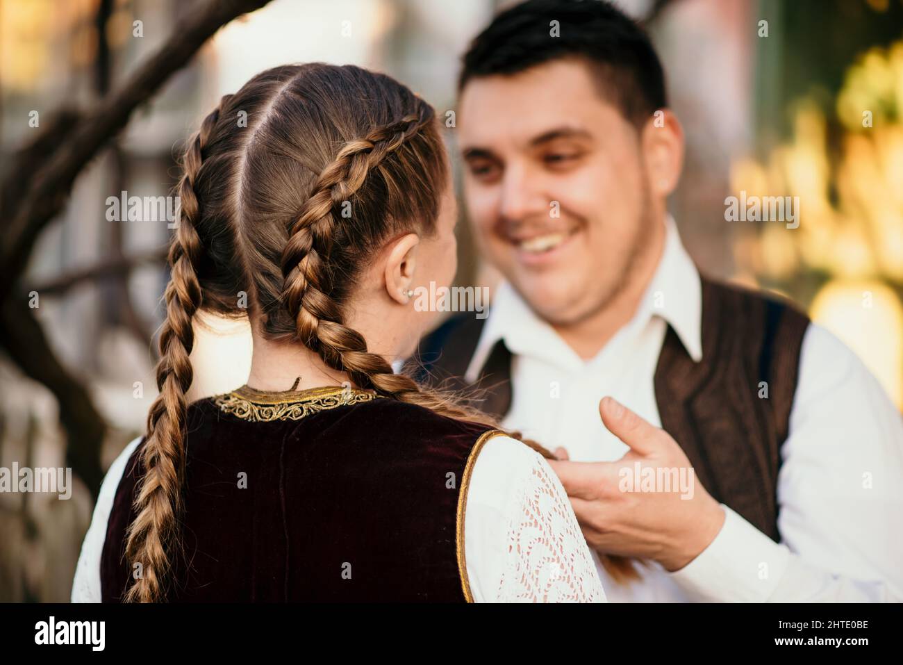 Beautiful shot of a Serbian couple in traditional costume posing for a ...