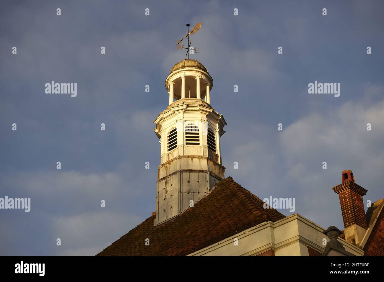 Low angle shot of a historic building in Rochester with weather vane ...