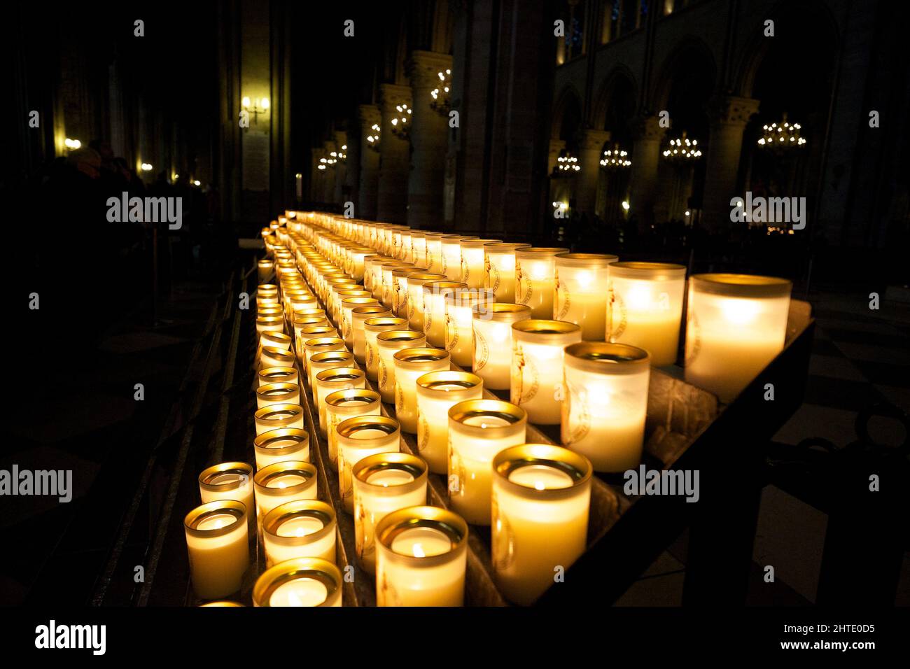 Closeup shot of rows of lit candles inside a temple in Bangkok ...