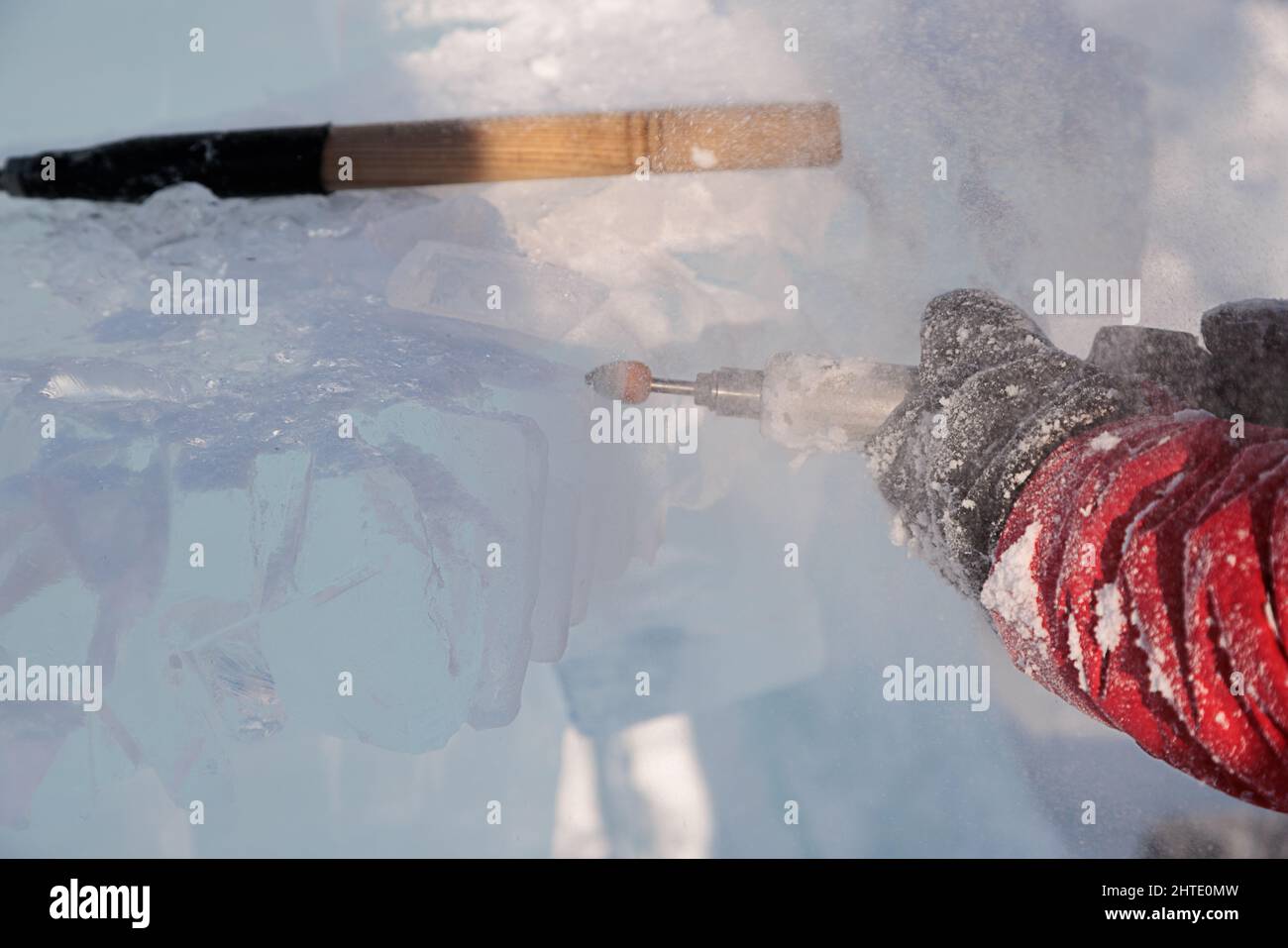 A man cuts ice with a special tool Stock Photo - Alamy