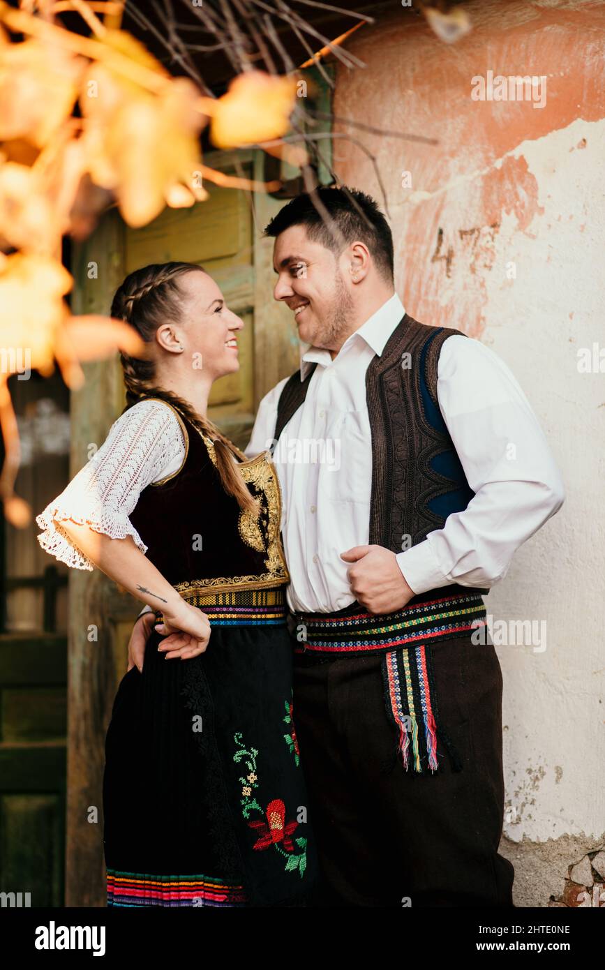 Beautiful shot of a Serbian couple in traditional costume posing for a ...