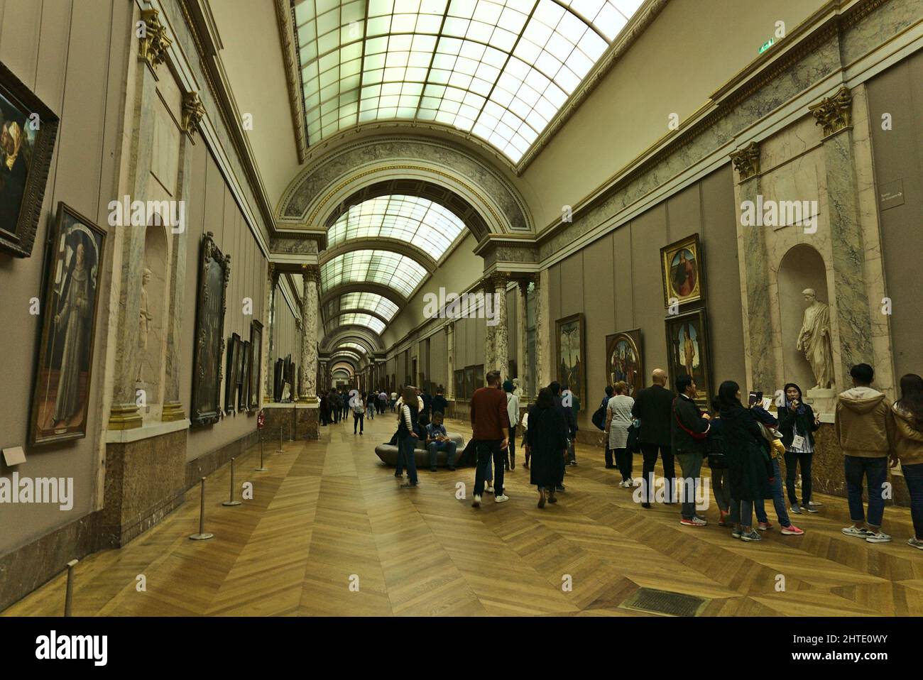 Closeup of the Louvre museum art halls and tourists, Paris in France ...