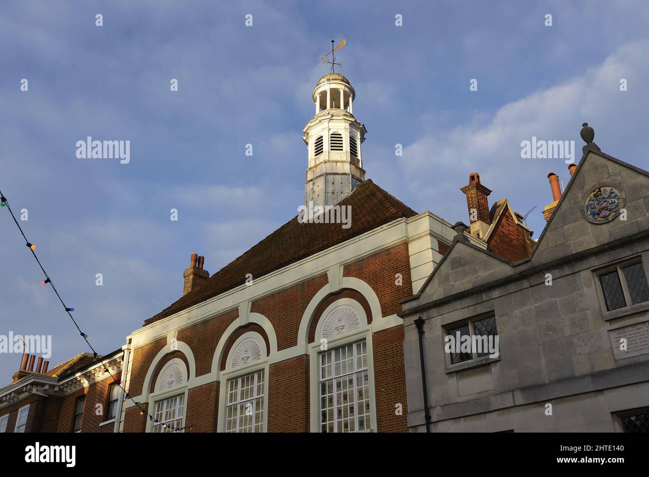 Low angle shot of a historic building in Rochester with a weather vane ...