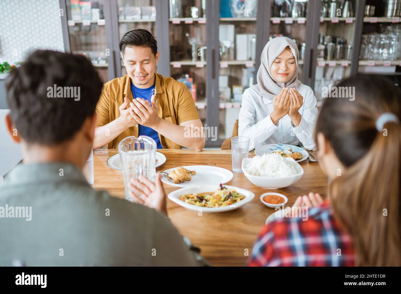 friends having fun eating lunch together at home with traditional food ...