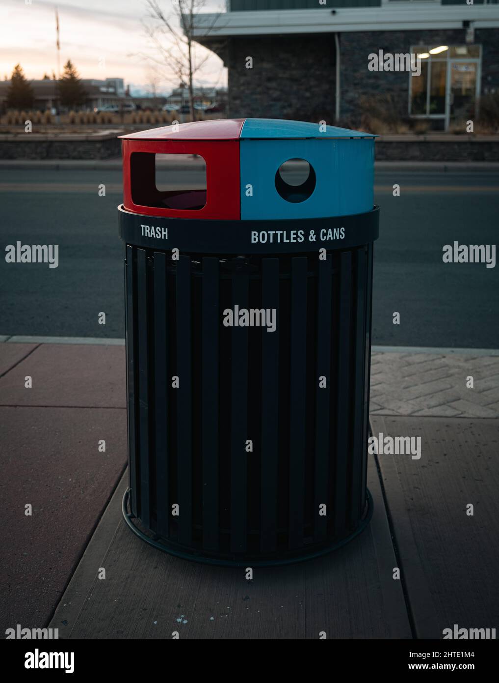 Vertical shot of a garbage bin separated between trash and bottles and ...