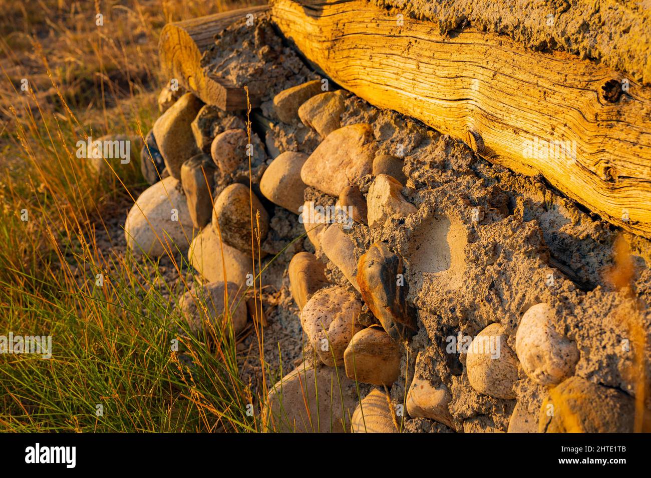 Closeup of stones on a wall and a wood Stock Photo - Alamy