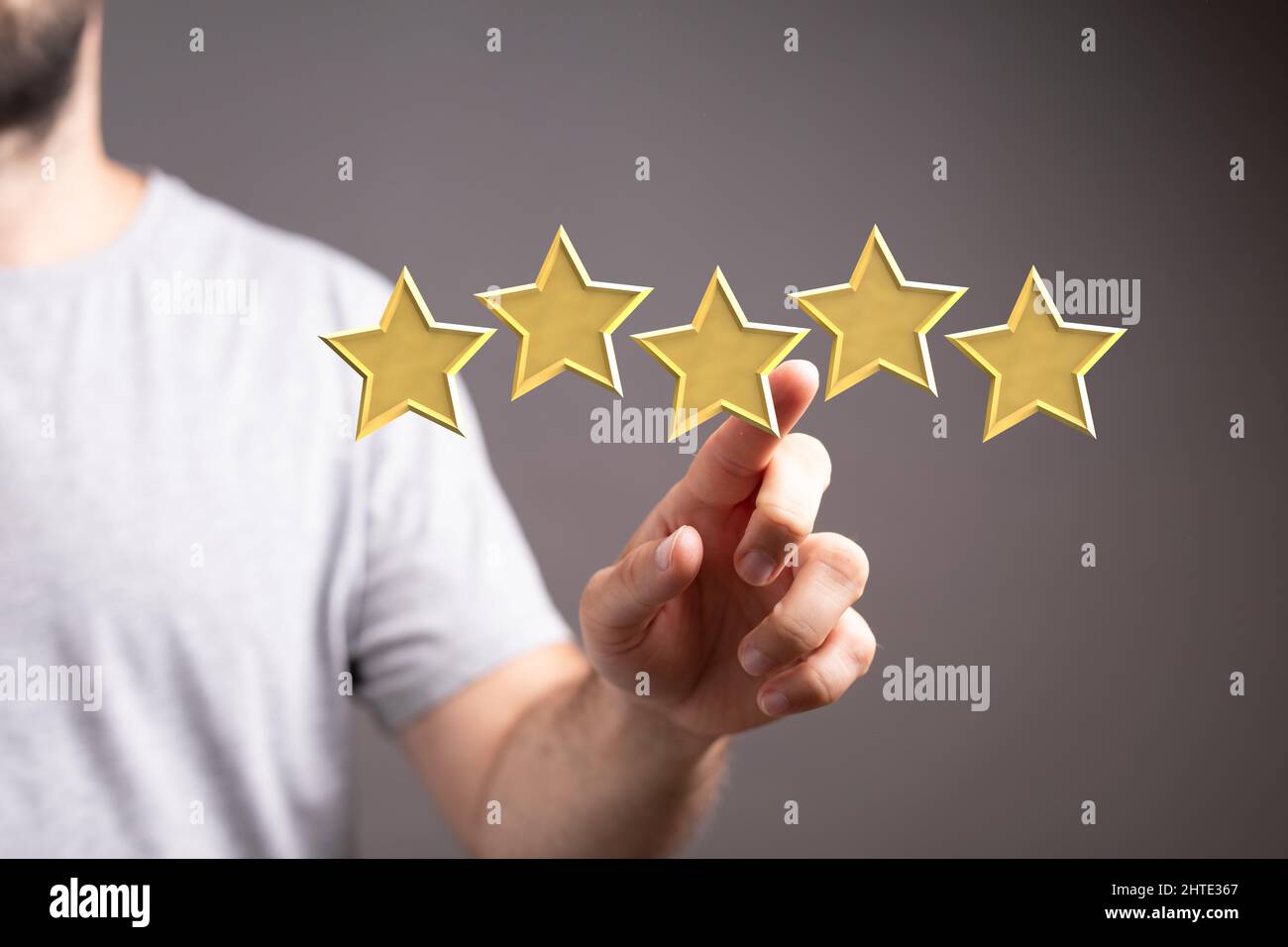 Male pointing at five-star symbols to increase the rating of the ...