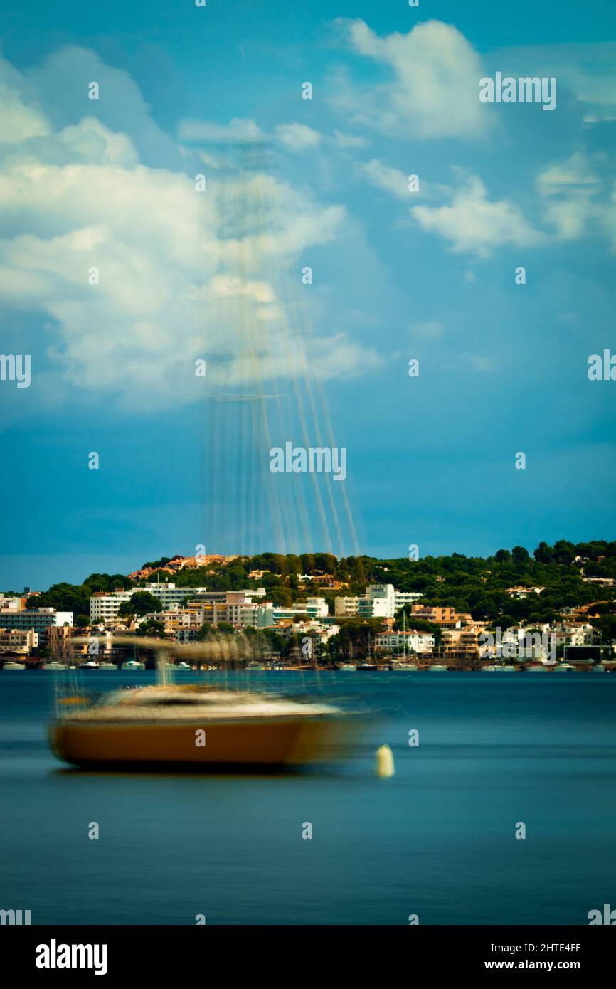 Vertical photo of a lake, a boat and houses on a forest hill in Geneva ...